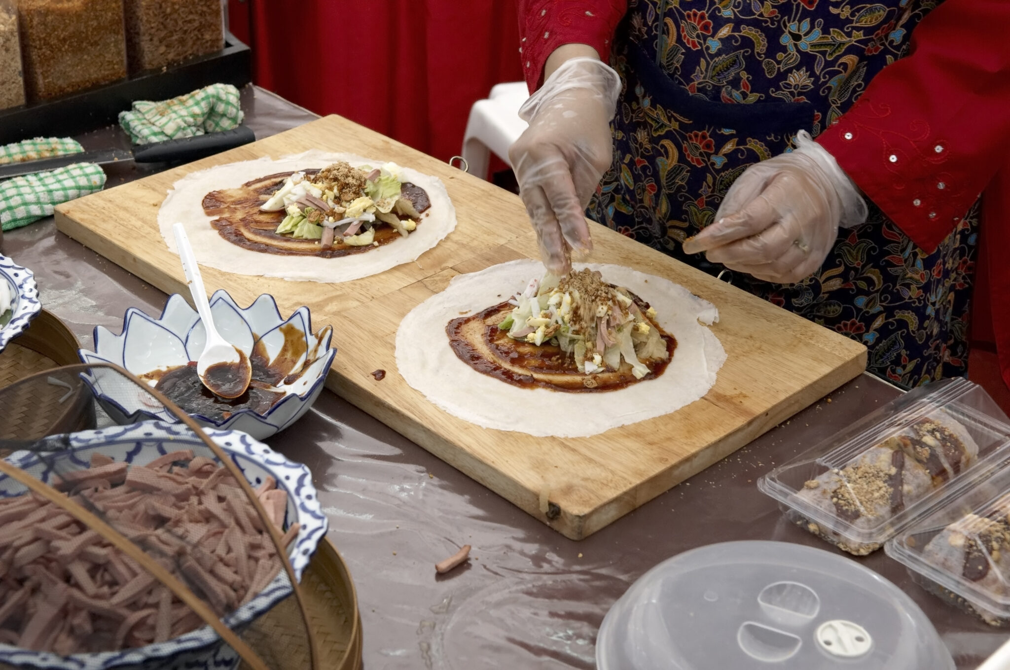 Spring roll being prepared on street food stall in Singapore - Expat ...